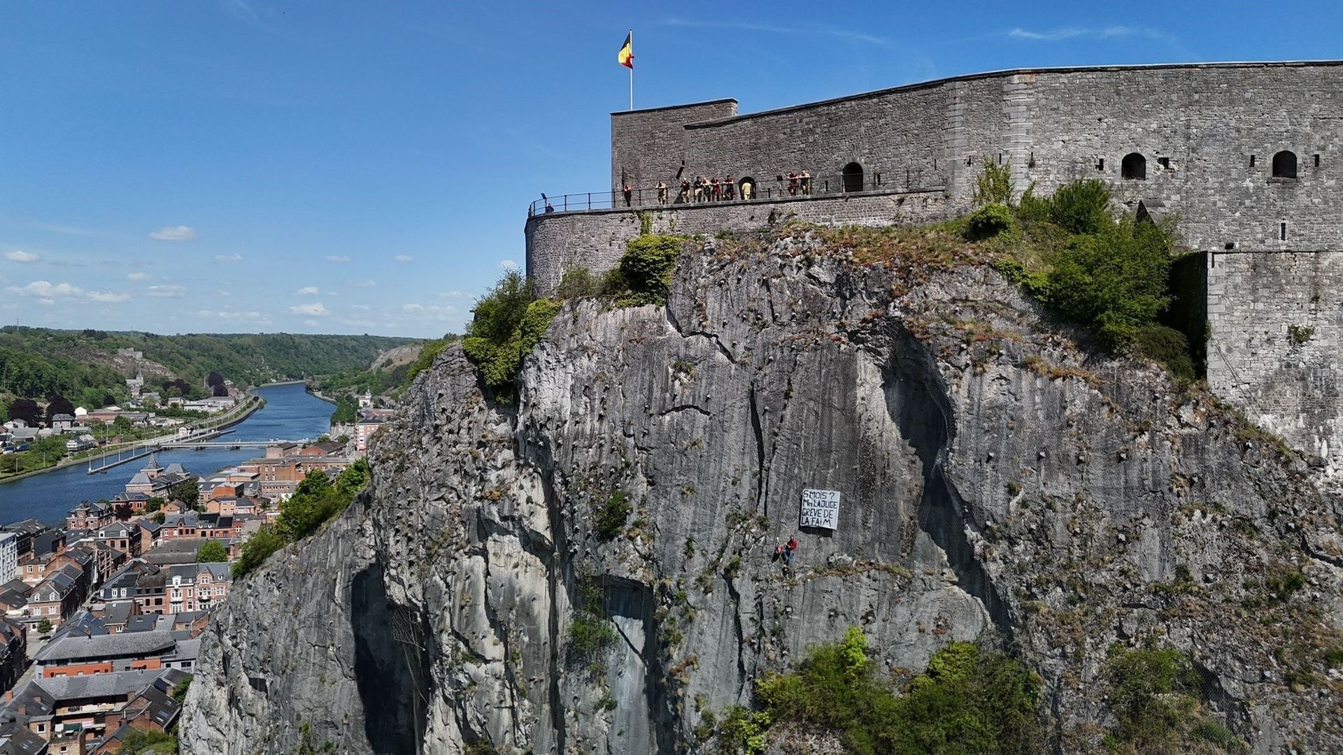 Un homme accroché dans le vide sur la falaise de la citadelle de Dinant ...